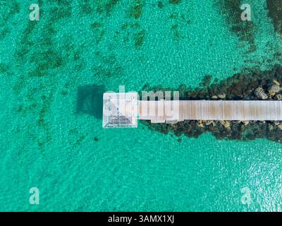 Aerial view of Sandyport beach with turquoise water and wooden shore ...