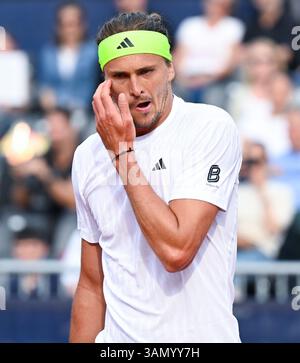 Munich, Germany. 14th Apr, 2025. The Olympic Tower can be seen behind the branches of a cherry ...