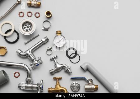 Set of plumber's items on grey background Stock Photo - Alamy