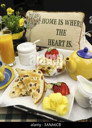 Breakfast with muesli, strawberries, orange juice on the wooden table ...