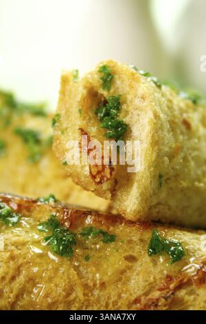 Vegetarian baked corn rolls dripping with parsley butter on a bed of ...