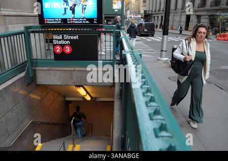 A person walks past the Wall Street subway station in the Financial ...