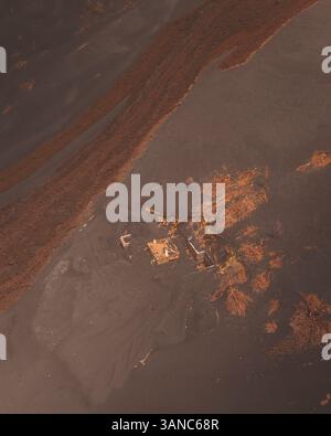 Aerial view of volcanic eruption with buried houses and lava flow, El ...