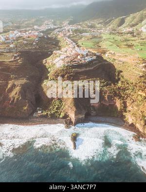 Dramatic cliffside view overlooking lush green valley under a cloudy ...