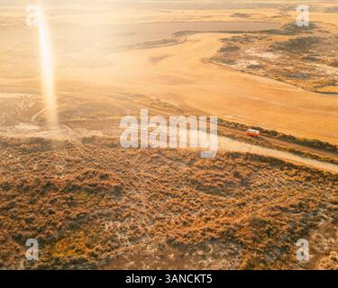 Aerial view of a vintage orange campervan, in the Bardenas Reales ...