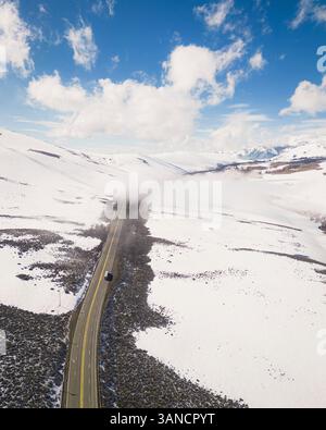An aerial view of a road leading to the frozen Loch Doon in Scotland ...