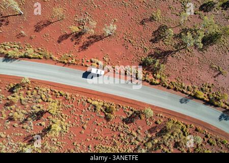 Aerial view of Weano Road with a campervan amidst the rugged red earth ...
