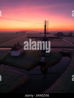 Natural landscape, silhouette of a windmill surrounded by vegetation at ...