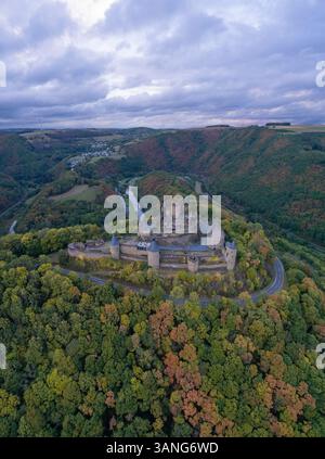 The aerial view of Bourscheid Castle on the hill with lush vegetation ...