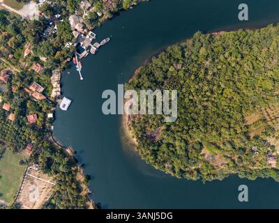 Aerial view of Teuk Chhou river with lush greenery, tranquil village ...