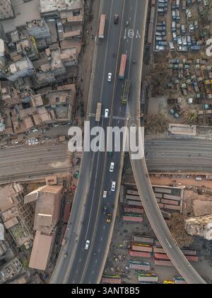 Aerial view of bustling junction road with a crowded bus station and ...