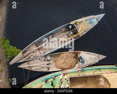 Aerial view of busy boats and cement industries along the river in an ...