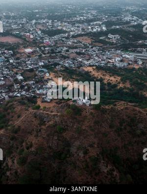 Aerial view of Gayatri Mata Temple on a scenic hill surrounded by rocky terrain and lush ...