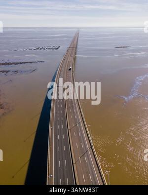 Aerial view of vehicles driving Vasco da Gama suspended bridge crossing ...