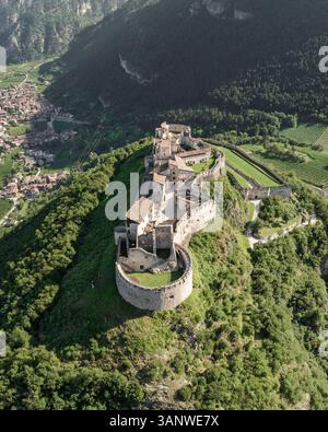 Aerial view of Castel Beseno on a hilltop surrounded by picturesque ...