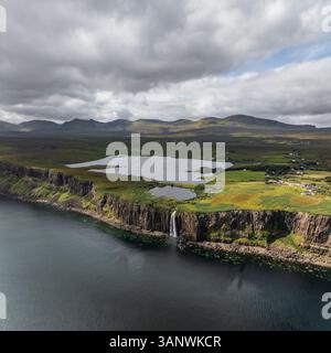 Aerial view of kilt rock waterfall cascading over rugged cliffs into ...
