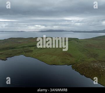 Aerial view of Loch Leathan surrounded by majestic mountains and lush ...