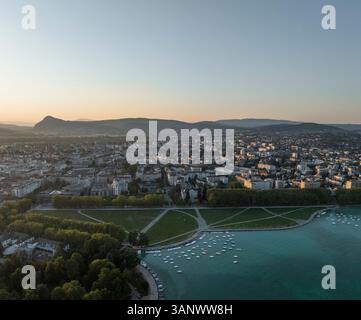 Aerial view of Annecy Lake surrounded by beautiful buildings and serene ...