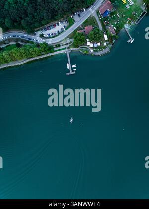 Aerial view of serene Viverone Lake surrounded by lush greenery and a ...