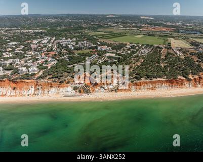 Beautiful landscape of Falesia Beach with high red and orange cliffs in ...