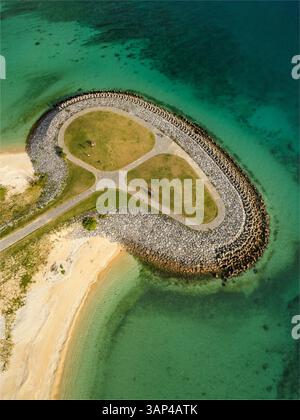 Aerial view of serene seikinomori beach with turquoise water and rocky ...