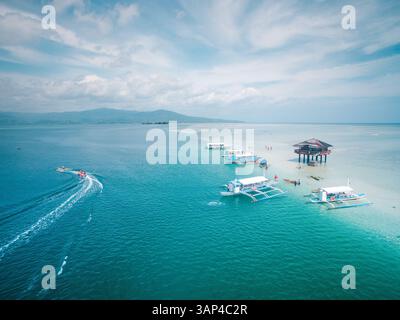 Aerial view of Manjuyod sandbar in the turquoise water of the sea on ...