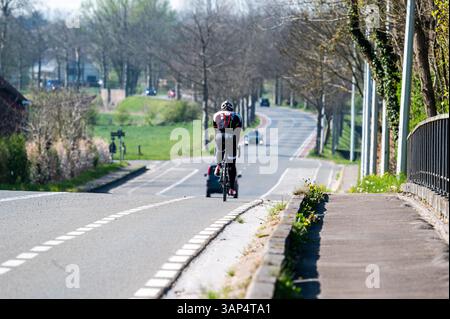 Race cyclist driving over a bridge in Zwalm, East Flemish Region ...