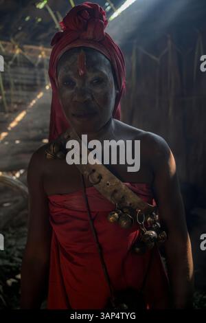 Portrait of a woman dressed in ritual attire and with her face painted ...