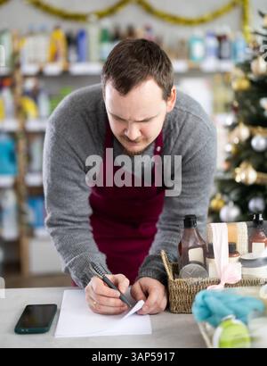 Male salesman makes notes on paper - keeps track of the receipt and ...