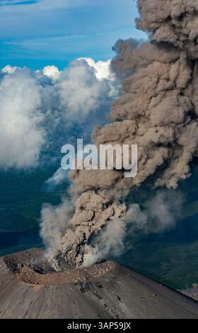 Aerial view of karymsky volcano with smoke plume and crater in a ...