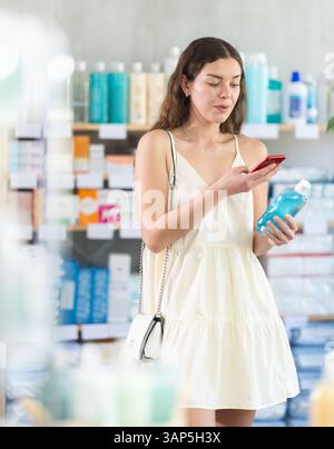 Woman in pharmacy scans QR code tablet paracetamol medication product ...