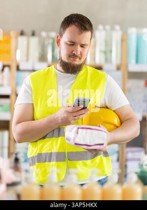 Guy buyer scans qr code on liquid detergent while shopping Stock Photo ...