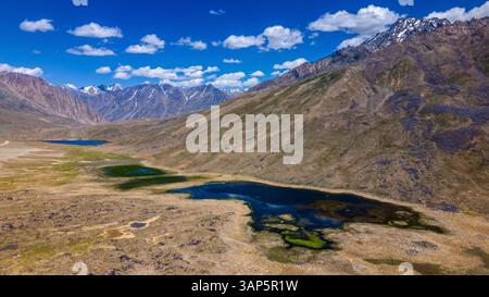 Aerial view of serene and pristine Shandur Lake surrounded by majestic ...