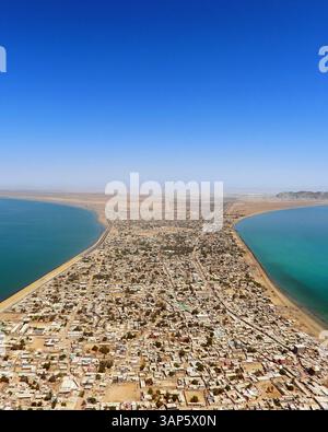 Aerial view of coastal city Gwadar with clear blue sky and waterfront ...