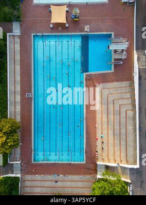 Aerial view of public pools with people swimming and enjoying summer ...