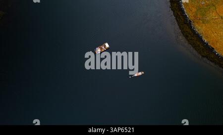 Aerial view of badcall bay with a fisherman boat and rocky shoreline ...