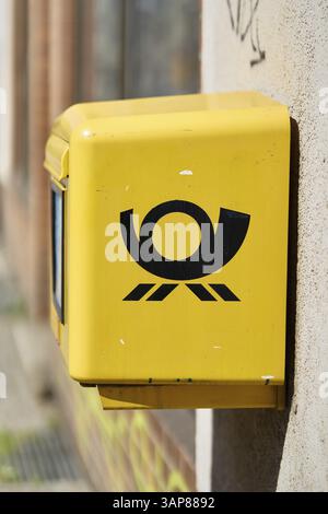 A yellow letterbox from the German postal service with the inscription ...