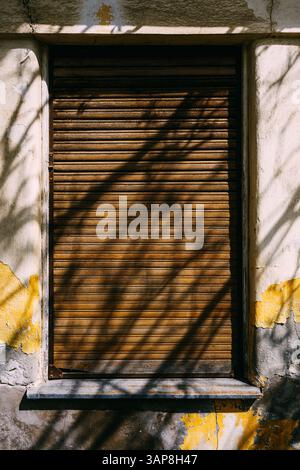 A vertical shot of a house with window shutters in Muhlheim am Main on ...