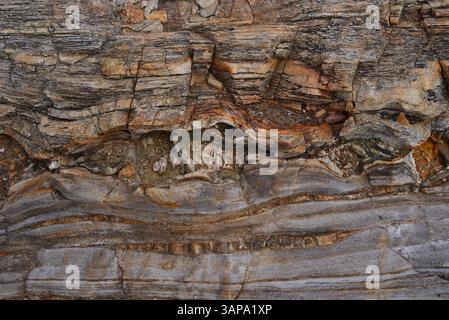 Stratified rock in different layers and materials Stock Photo - Alamy