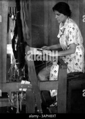 Photograph of Jane Chase spinning and weaving at a loom, part of the ...