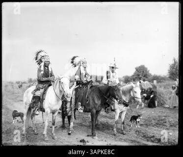 A group of Yakima Indian men, including White Swan, mounted in regalia ...