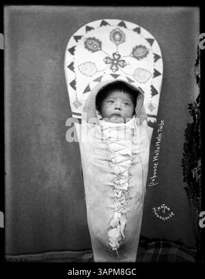 This photograph shows tribal infants in cradles, offering a glimpse ...