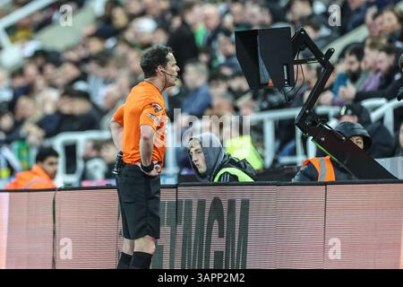 Referee Darren England checks VAR for handball during the Premier ...