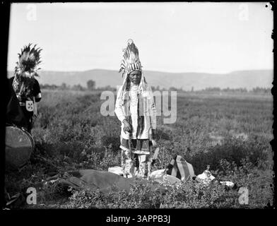 The photograph features a Yakima Indian singer dressed in traditional ...