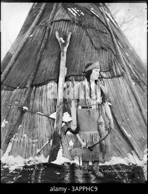 Photograph by Lee Moorhouse of a tribal woman in regalia, shooting a ...