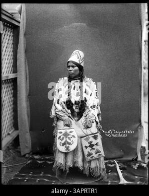 Photograph by Lee Moorhouse of a tribal woman in regalia, shooting a ...