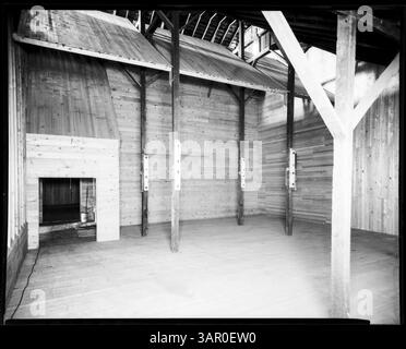 This historical photograph captures the interior of a factory located ...