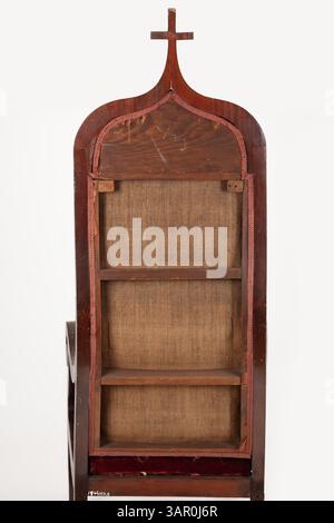 A high-backed priest's chair featuring a red velvet upholstered seat ...