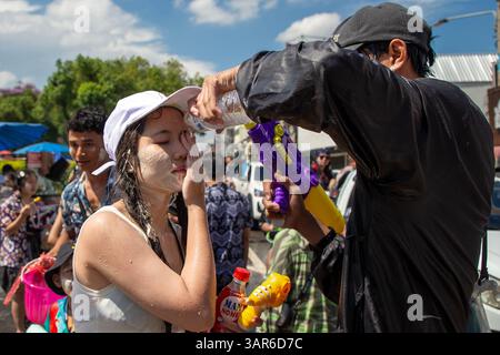 Thailand. 15th Apr, 2025. A couple is seen washing din sor pong (white ...
