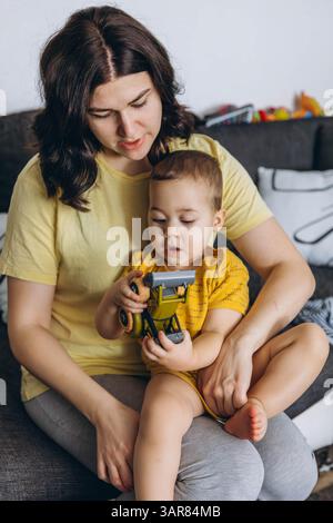 Mother changing a baby diaper Photo: Fotograferna Holmberg / TT / code ...